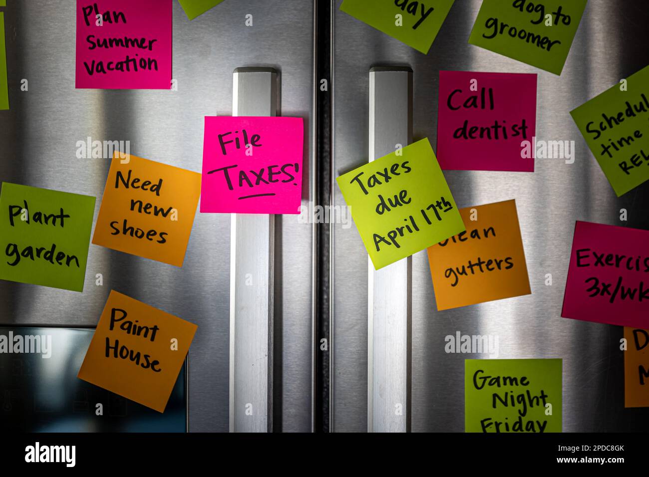 Refrigerator door with colorful memo notes reminding to file taxes on ...