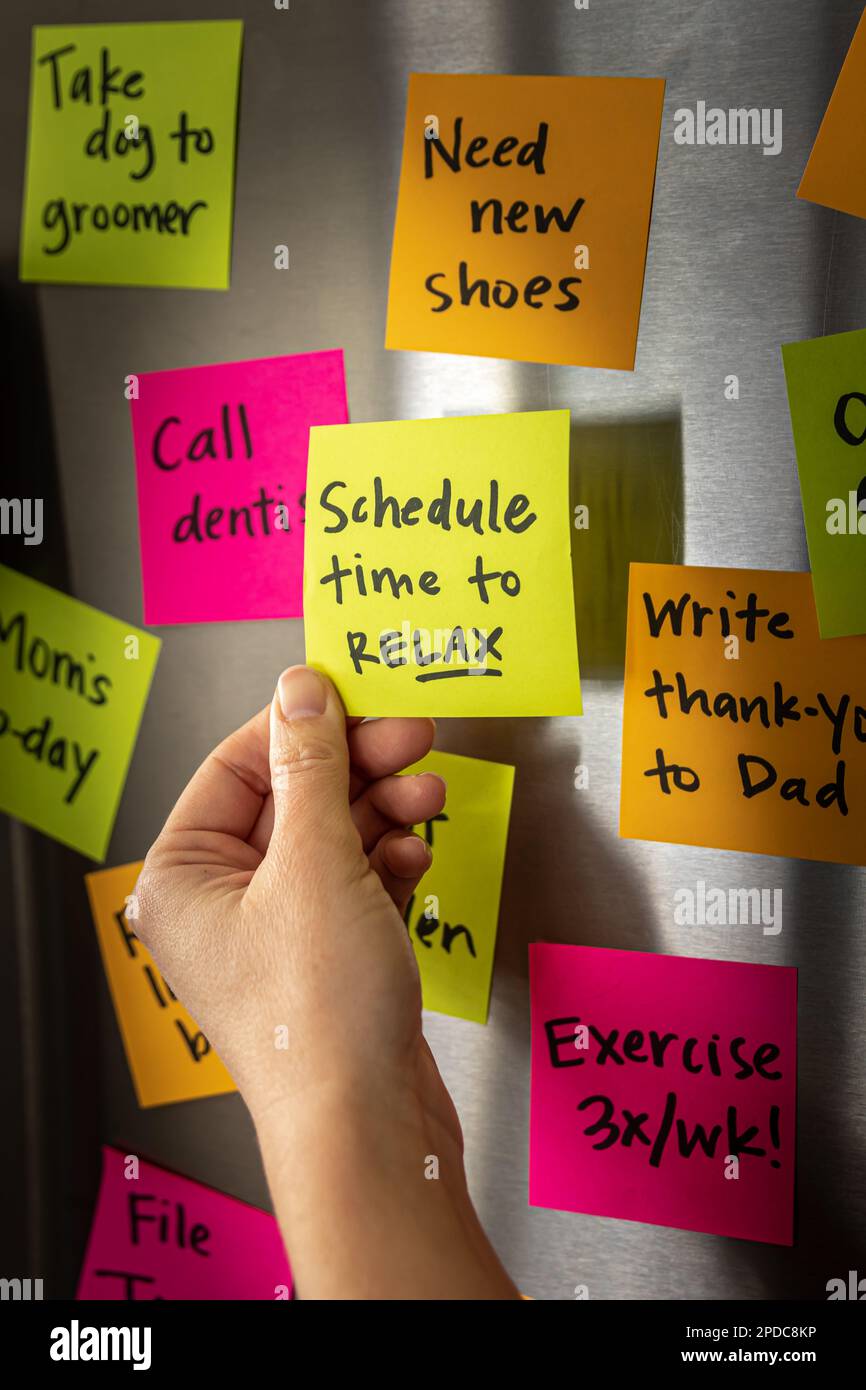 Hand Holding Schedule Time to Relax Sticky Note Memo to Fridge Door ...