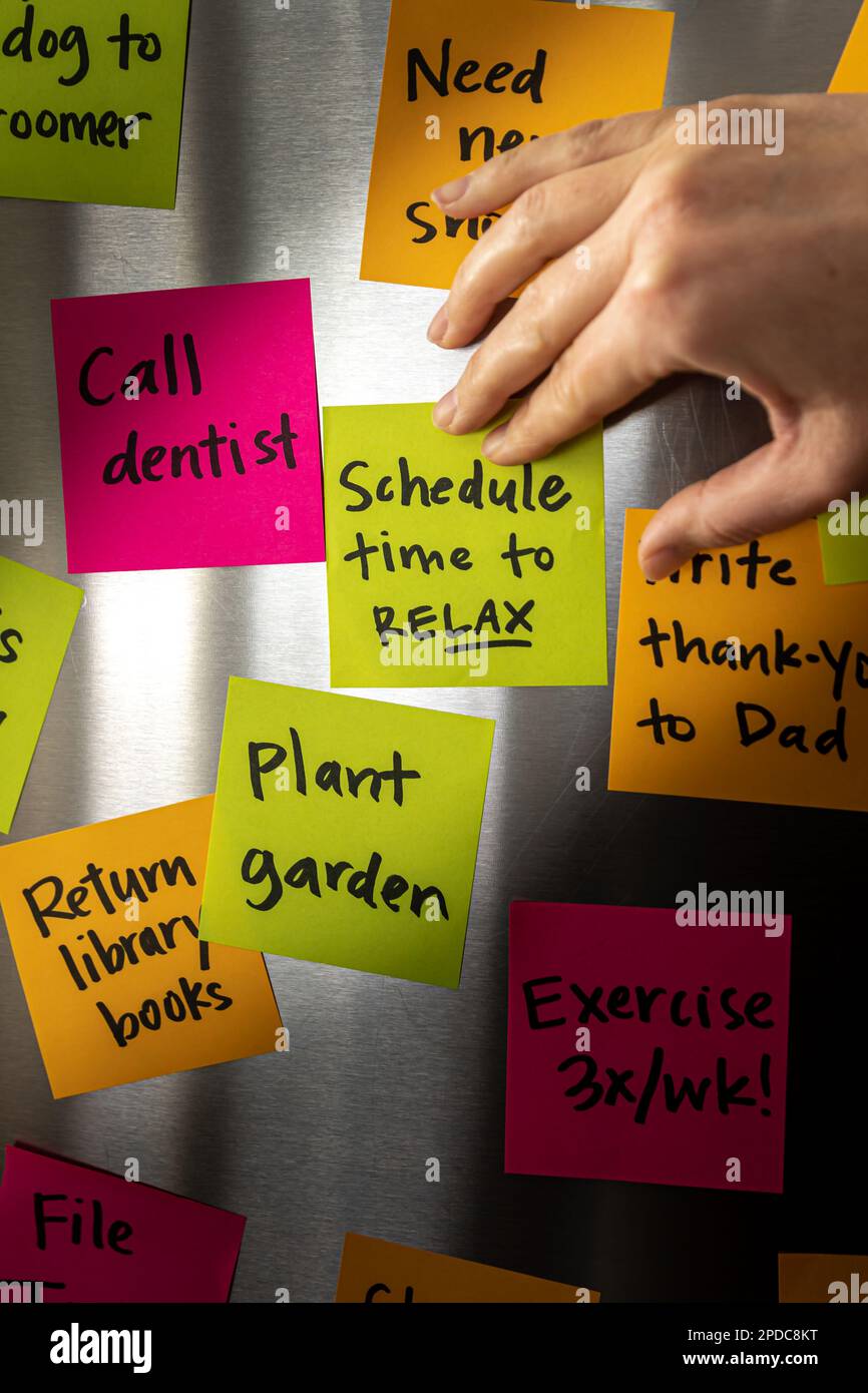 Hand Holding Schedule Time to Relax Sticky Note Memo to Fridge Door ...
