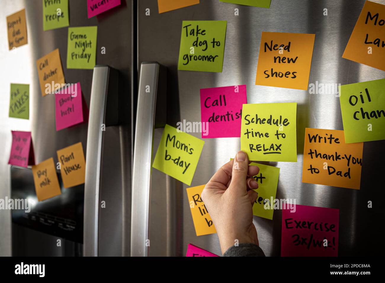 Hand Holding Schedule Time to Relax Sticky Note Memo to Fridge Door ...