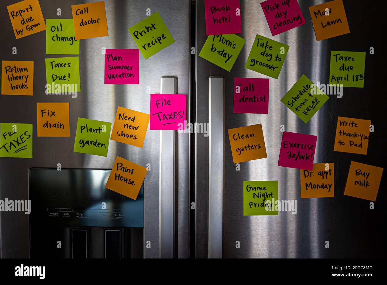 Refrigerator door with colorful memo notes reminding to file taxes ...
