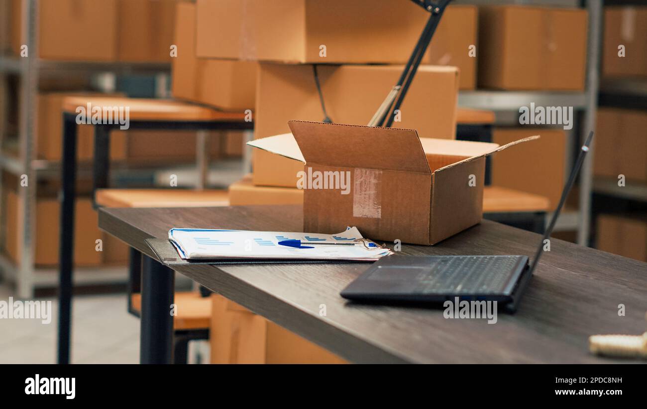 Storehouse space and desk filled with cardboard boxes and goods ...