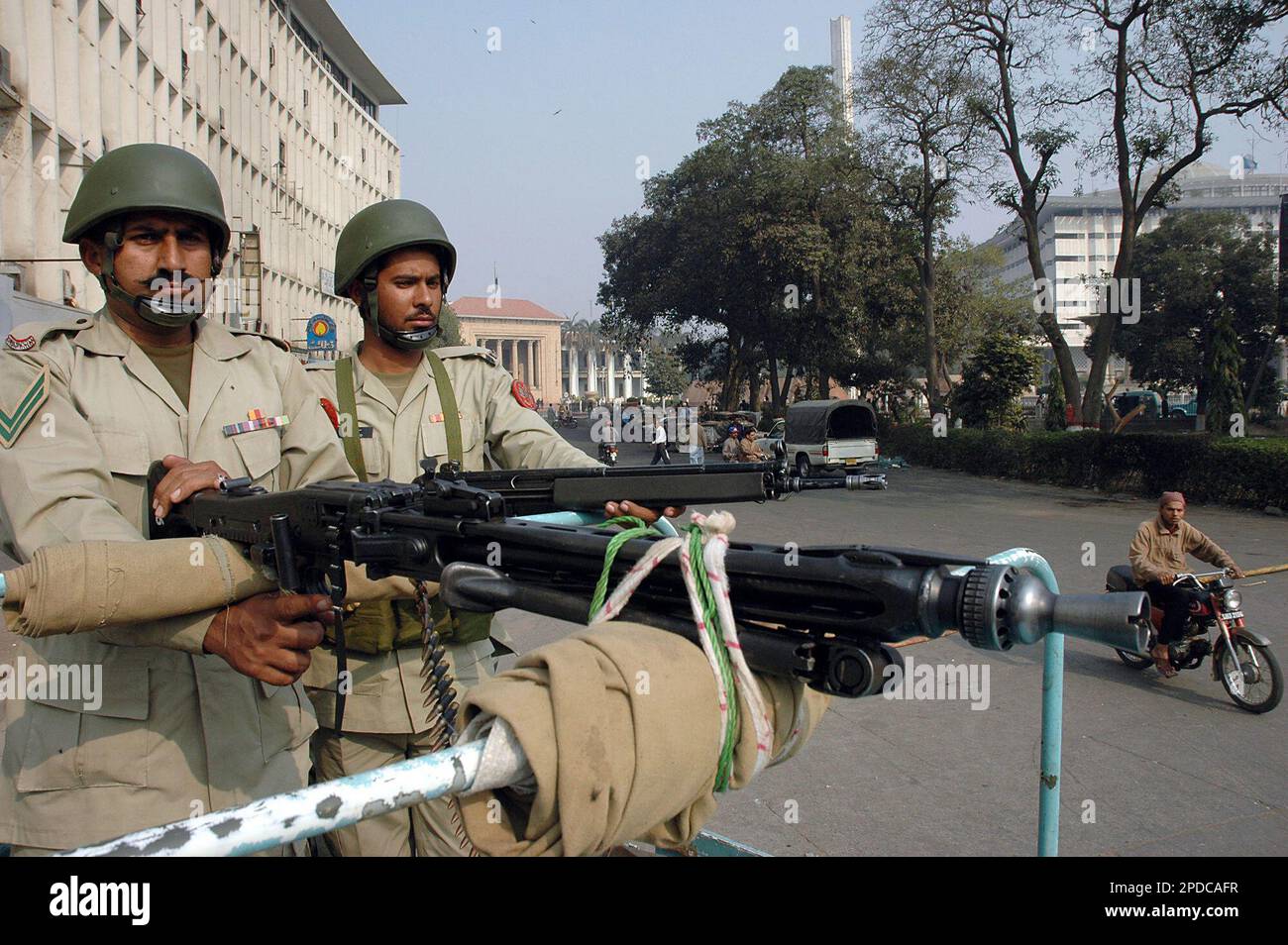 Pakistani paramilitary troops keep guard at a street to ensure security ...