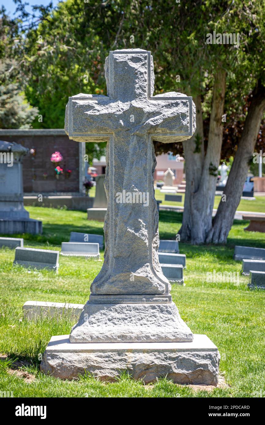A large religious cross-shaped stone headstone at a cemetery Stock ...