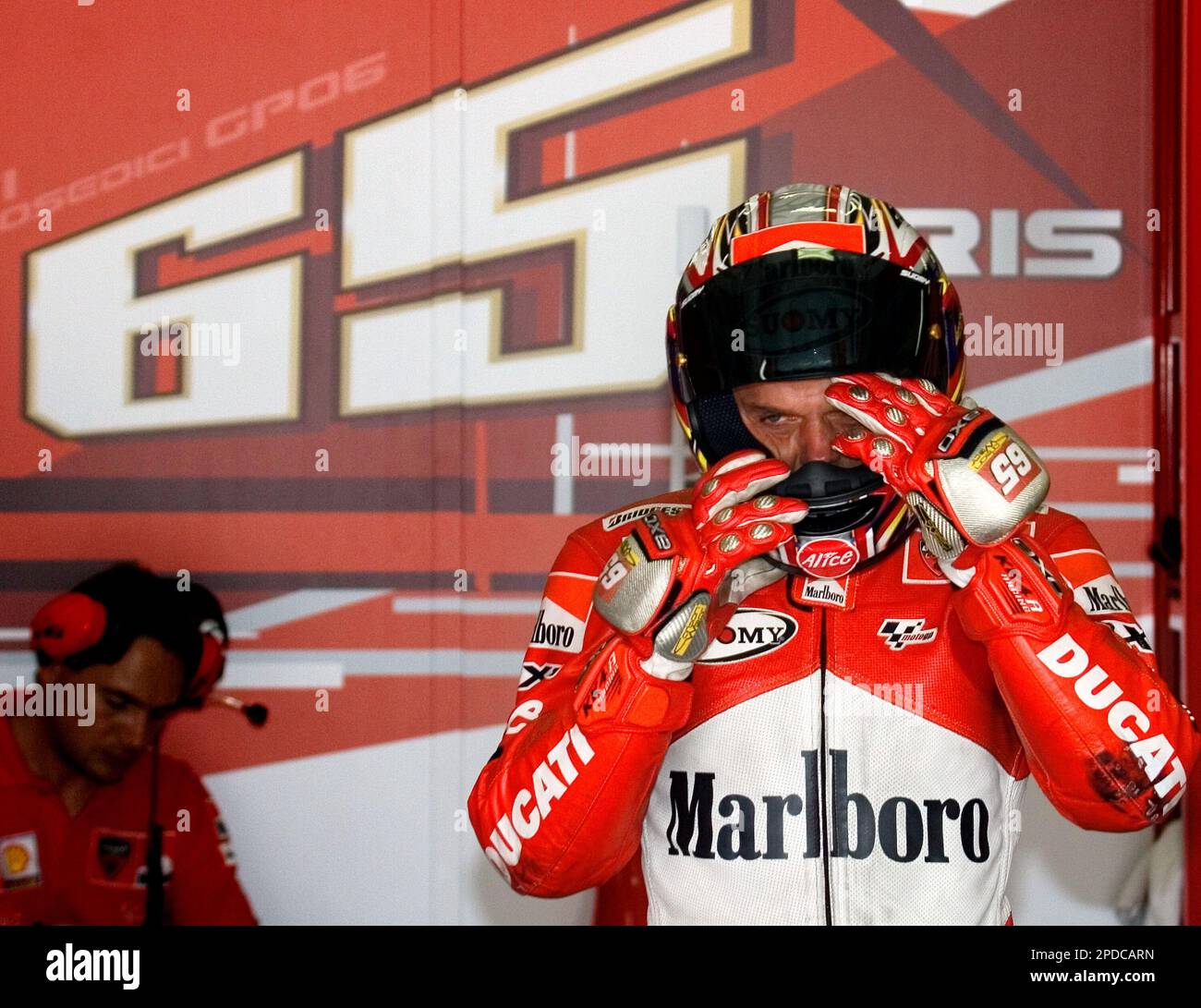 Italian Loris Capirossi of Marlboro Ducati team adjusts his helmet ...