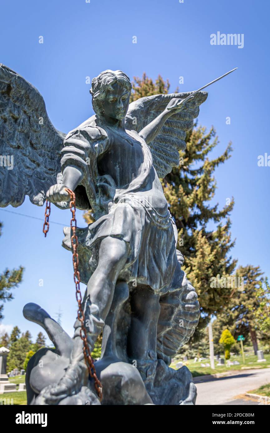 Statue of Micheal the Archangel statue holding a sword at the cemetery ...
