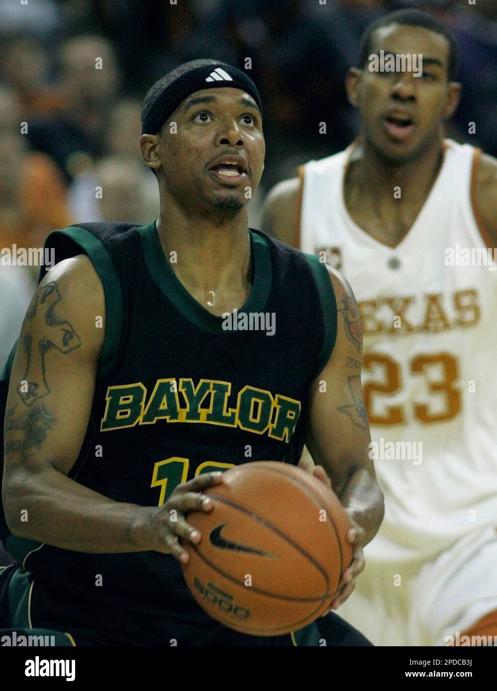 Baylor forward Patrick Fields, left, moves toward the basket ahead of ...