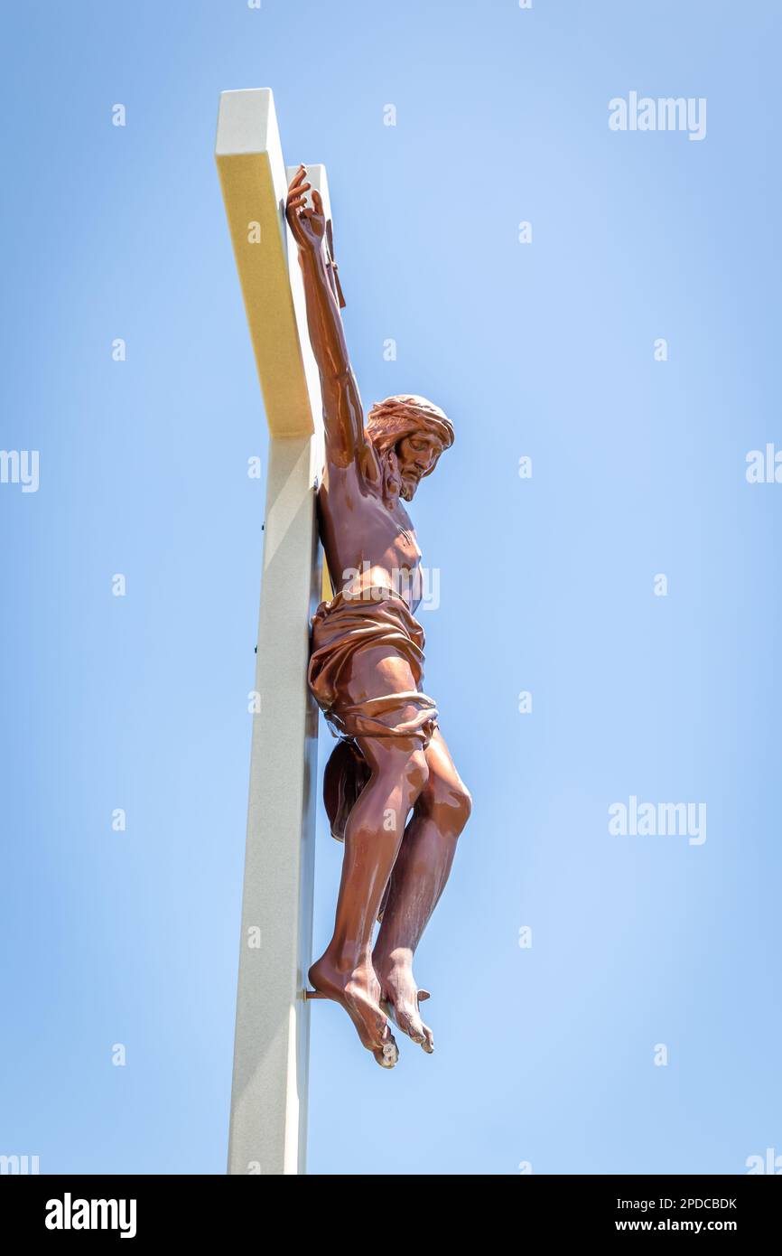 Gold colored statue at a cemetery of Jesus Christ hanging on the cross ...