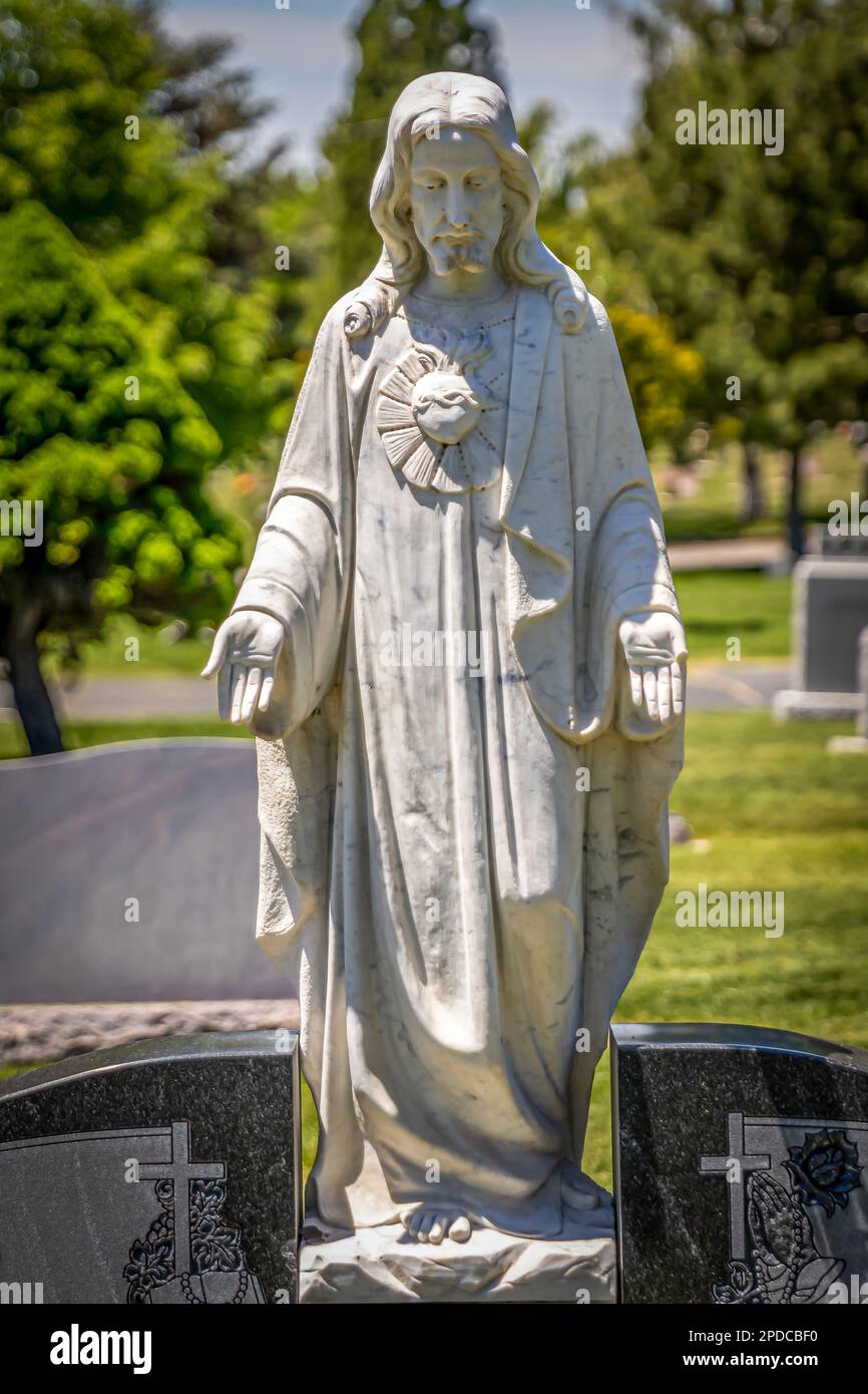 Stone statue of Jesus Christ holding out his hands mounted on the top ...