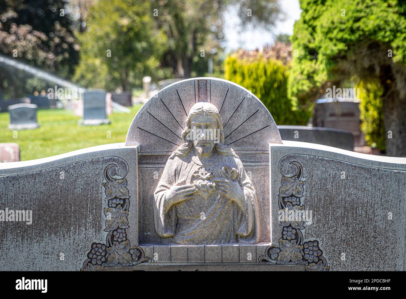 Stone statue of Jesus Christ pointing at His Sacred Heart on a ...