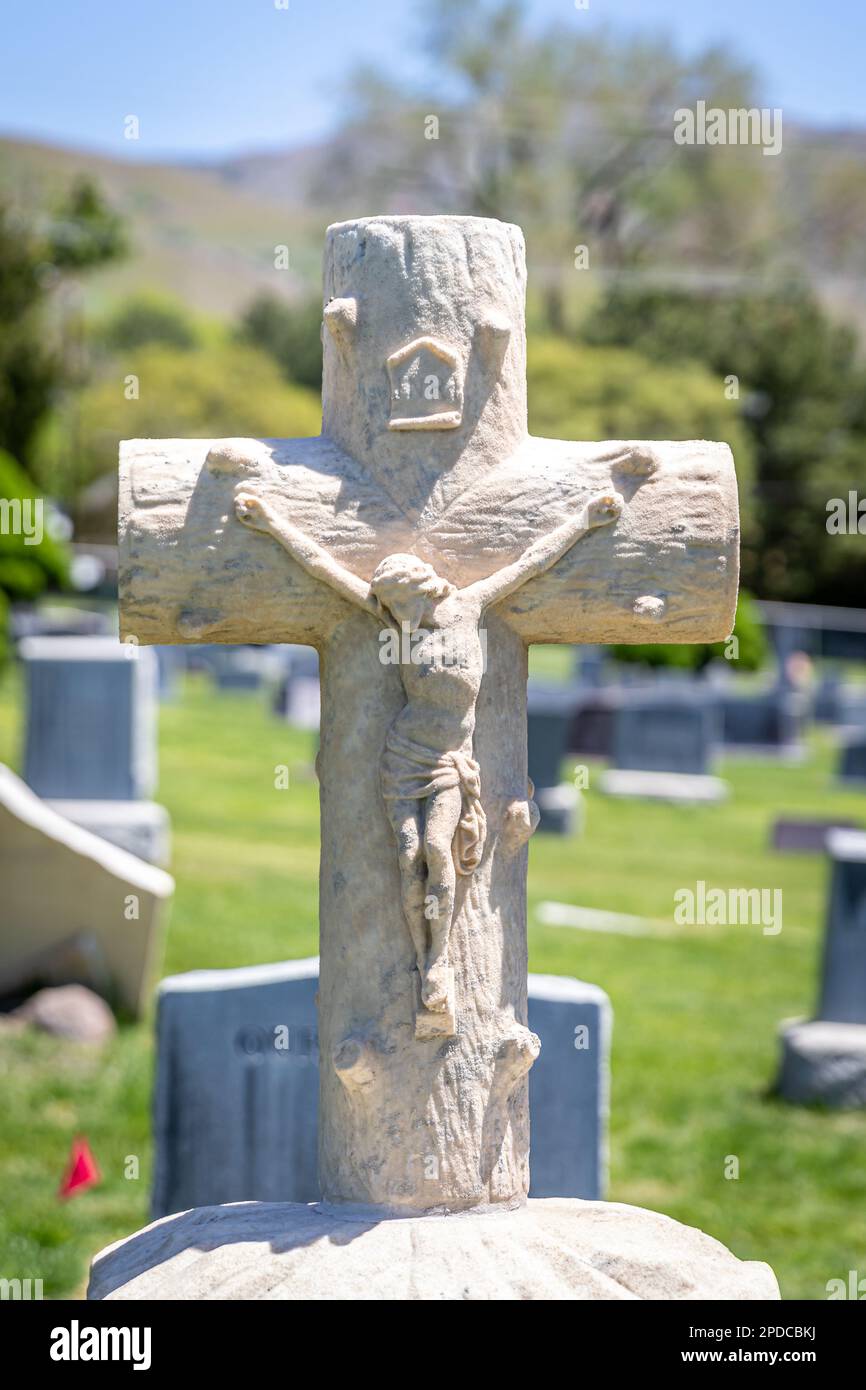 Stone grave marker of Jesus Christ hanging on the cross at a cemetery ...