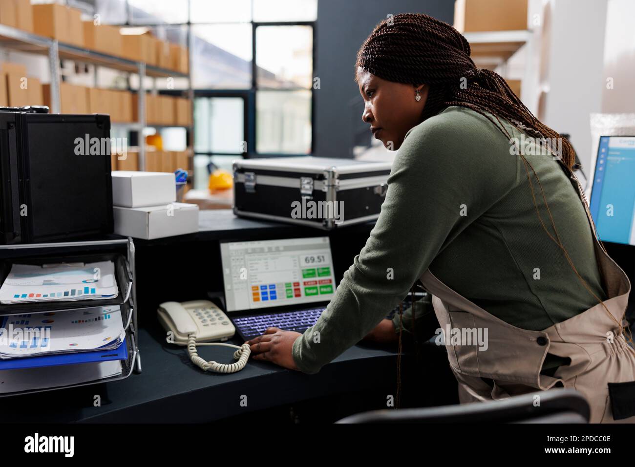 African american supervisor analyzing merchandise logistics on laptop ...
