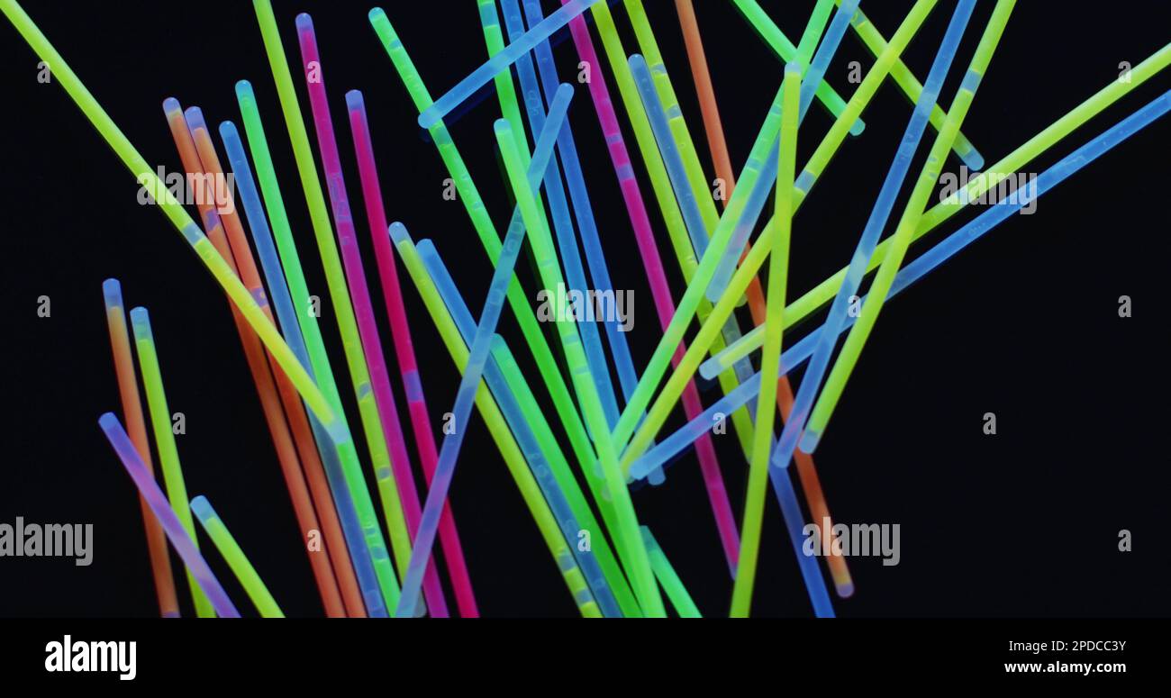 Image of multiple colorful neon glow sticks over black background Stock ...
