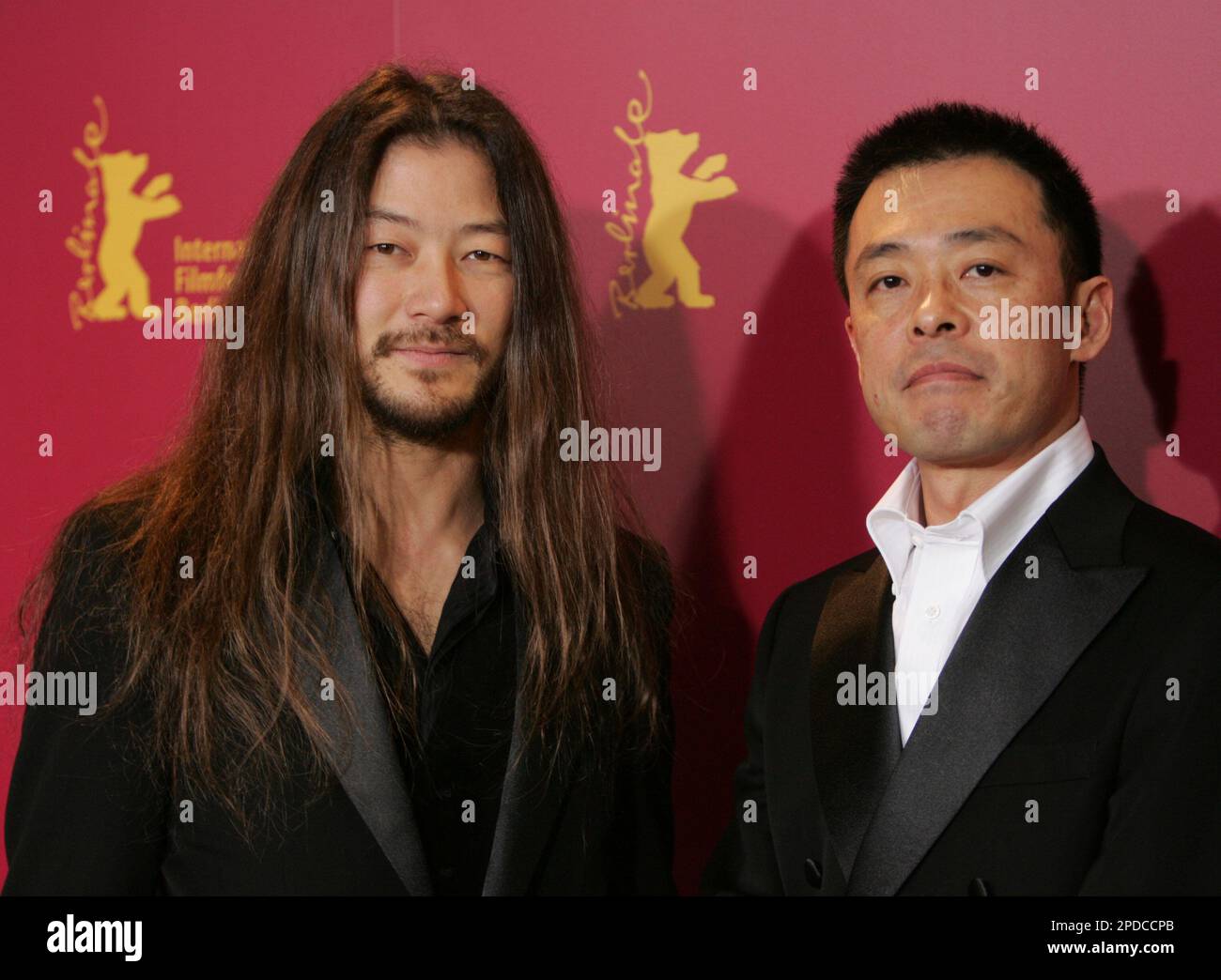 Japanese actors Asano Tadanobu, left, and Ken Mitsuishi pose during a ...