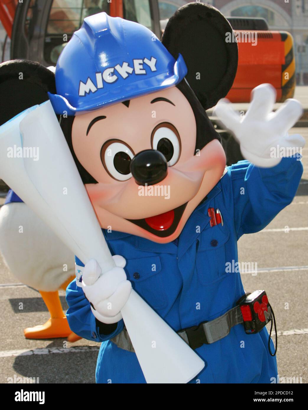 Mickey Mouse in construction worker's outfit waves at the guests during ...