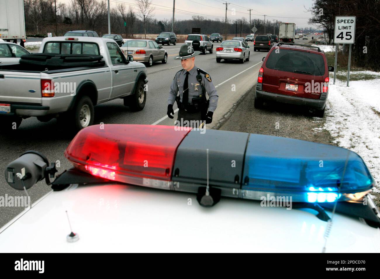Ohio State Trooper Todd Heck returns to his car on the southbound lane ...