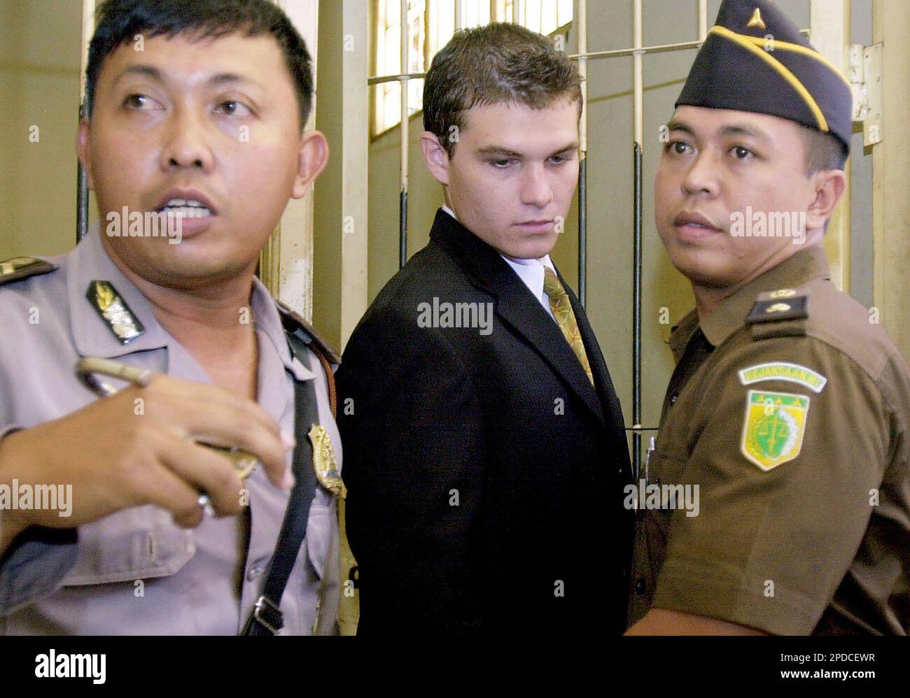 Australian Scott Rush, center, is led by Indonesia officers to a court ...