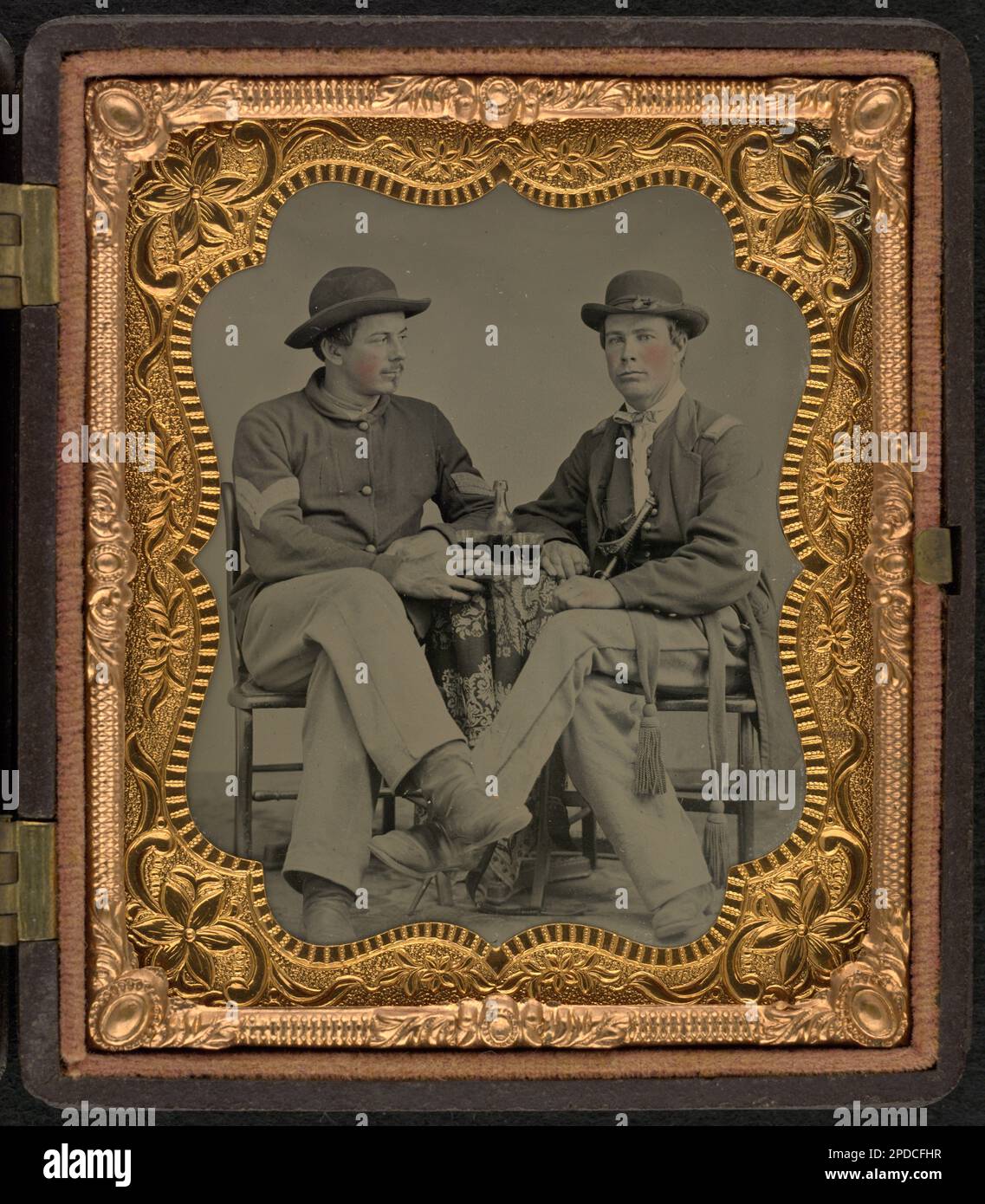 Two unidentified soldiers in Union uniforms seated at a table and ...