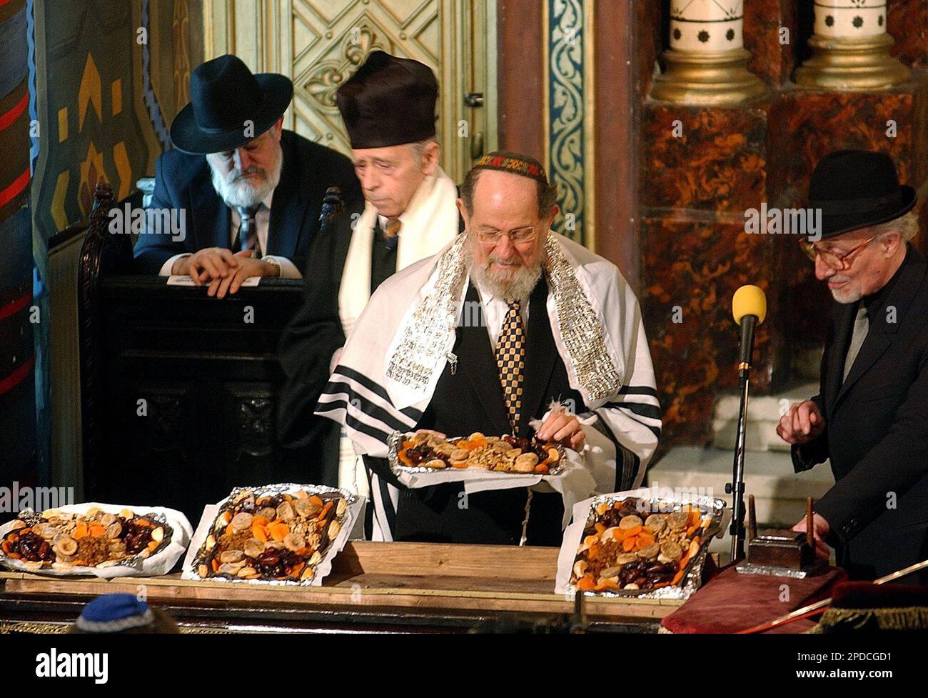 The Chief Rabbi of Romania, Menachem Hacohen holds a tray of fruits ...