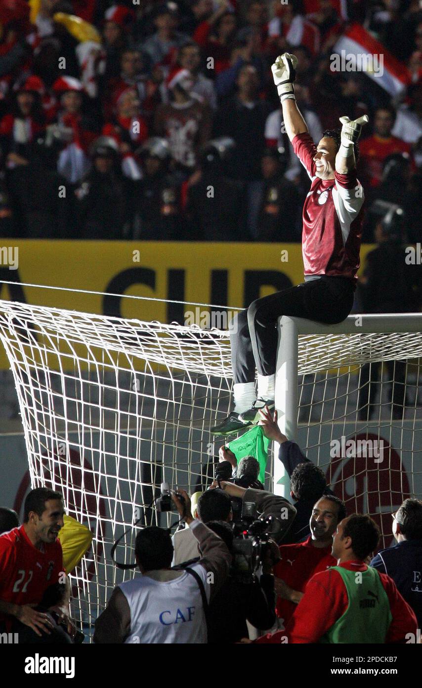 Egypt goalkeeper Essam Al Hadari celebrates on top of the goal, as ...