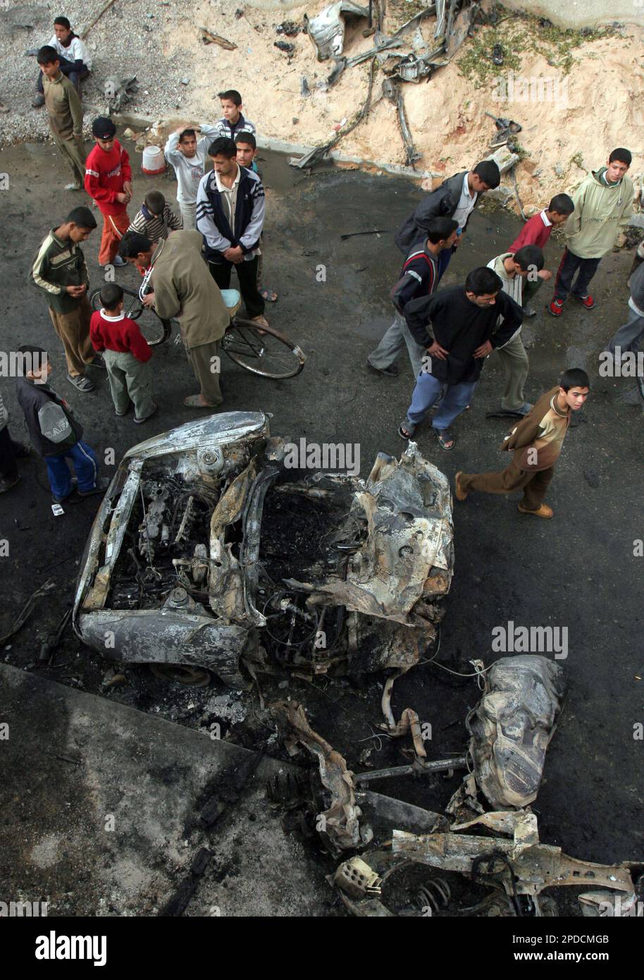 Residents of Dora neighborhood in south Baghdad gather at the site of ...
