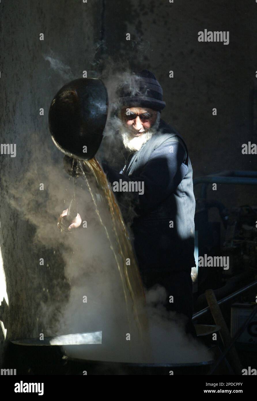 A Shia in Afghanistan prepares food in a community kitchen which will ...