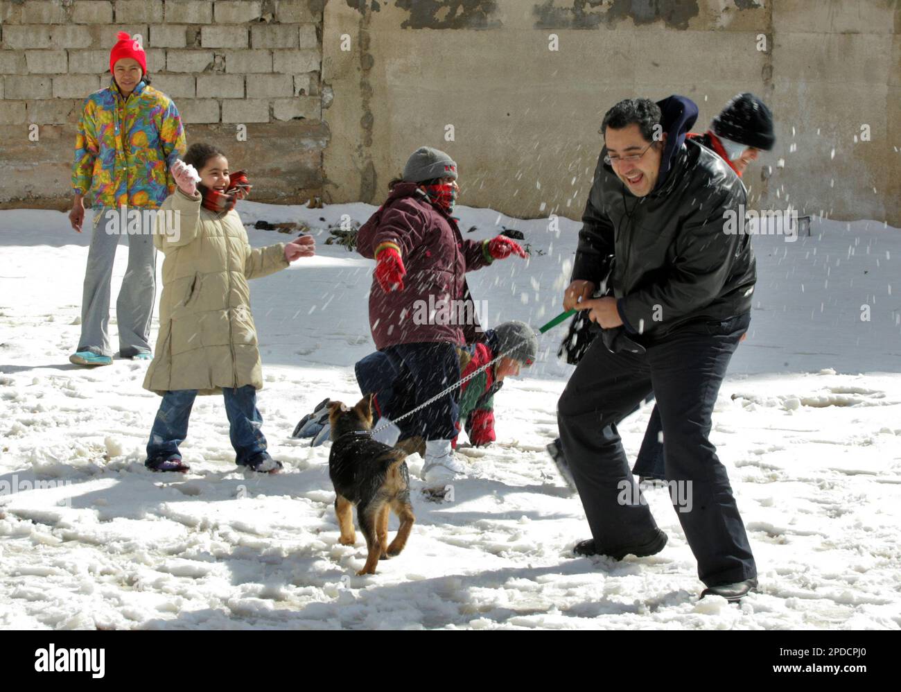 A Jordanian family plays in the snow in Amman, Jordan, on Thursday, Feb ...