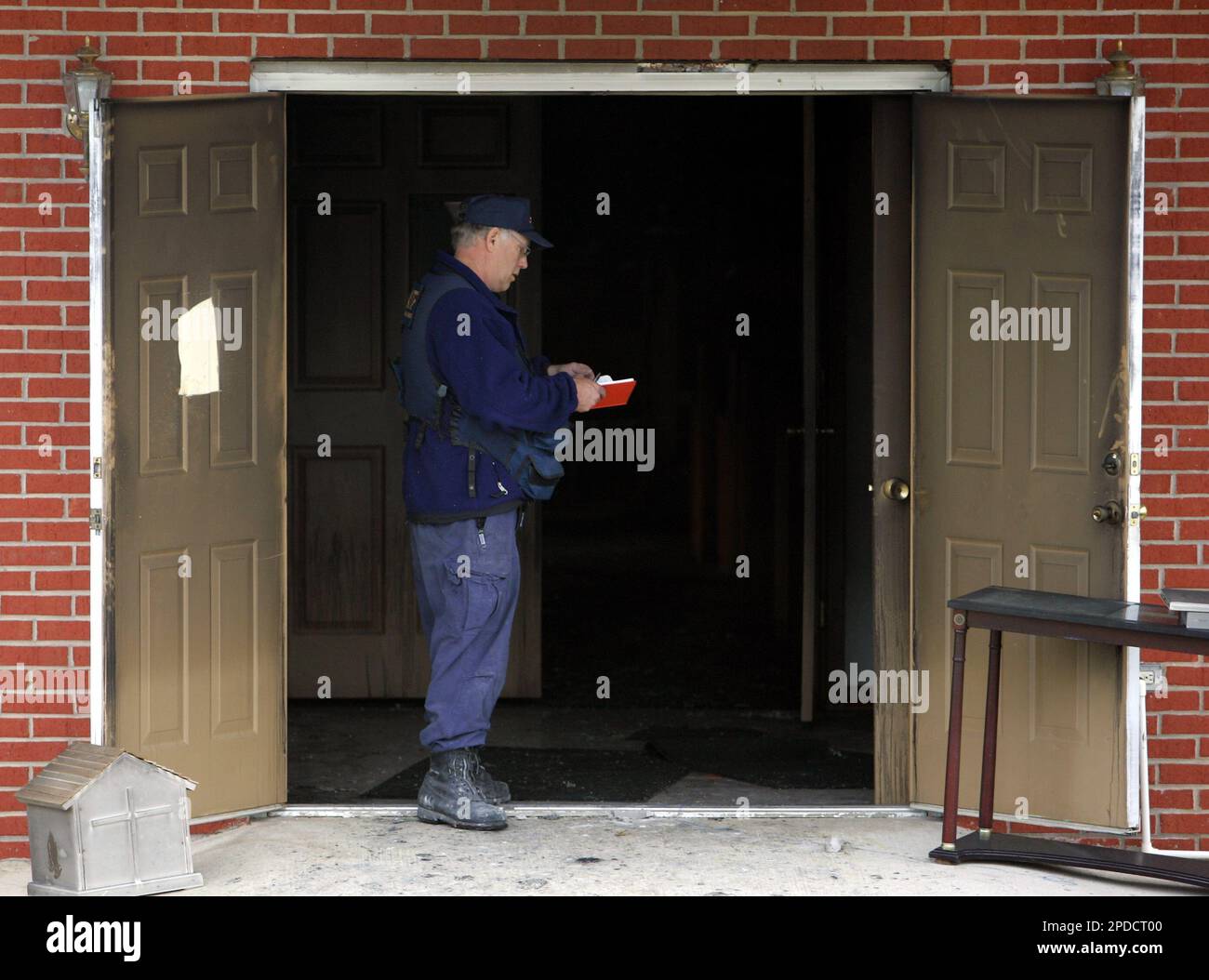 An agent with the Bureau of Alcohol, Tobacco and Firearms stands in the ...