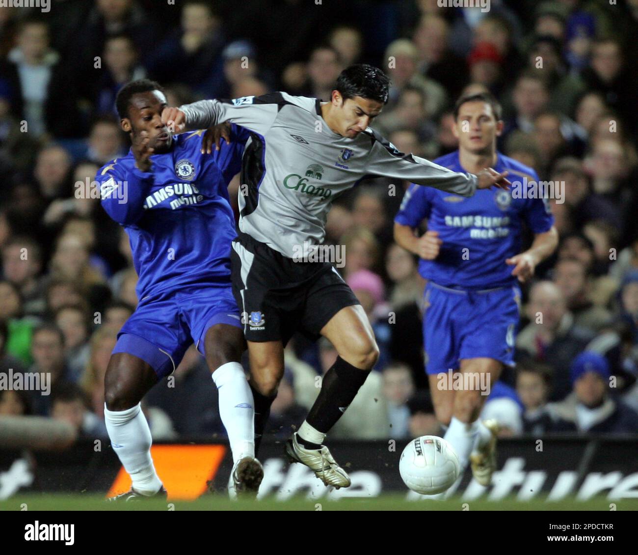 Chelsea's Michael Essien, left, tackles Everton's Tim Cahill during ...