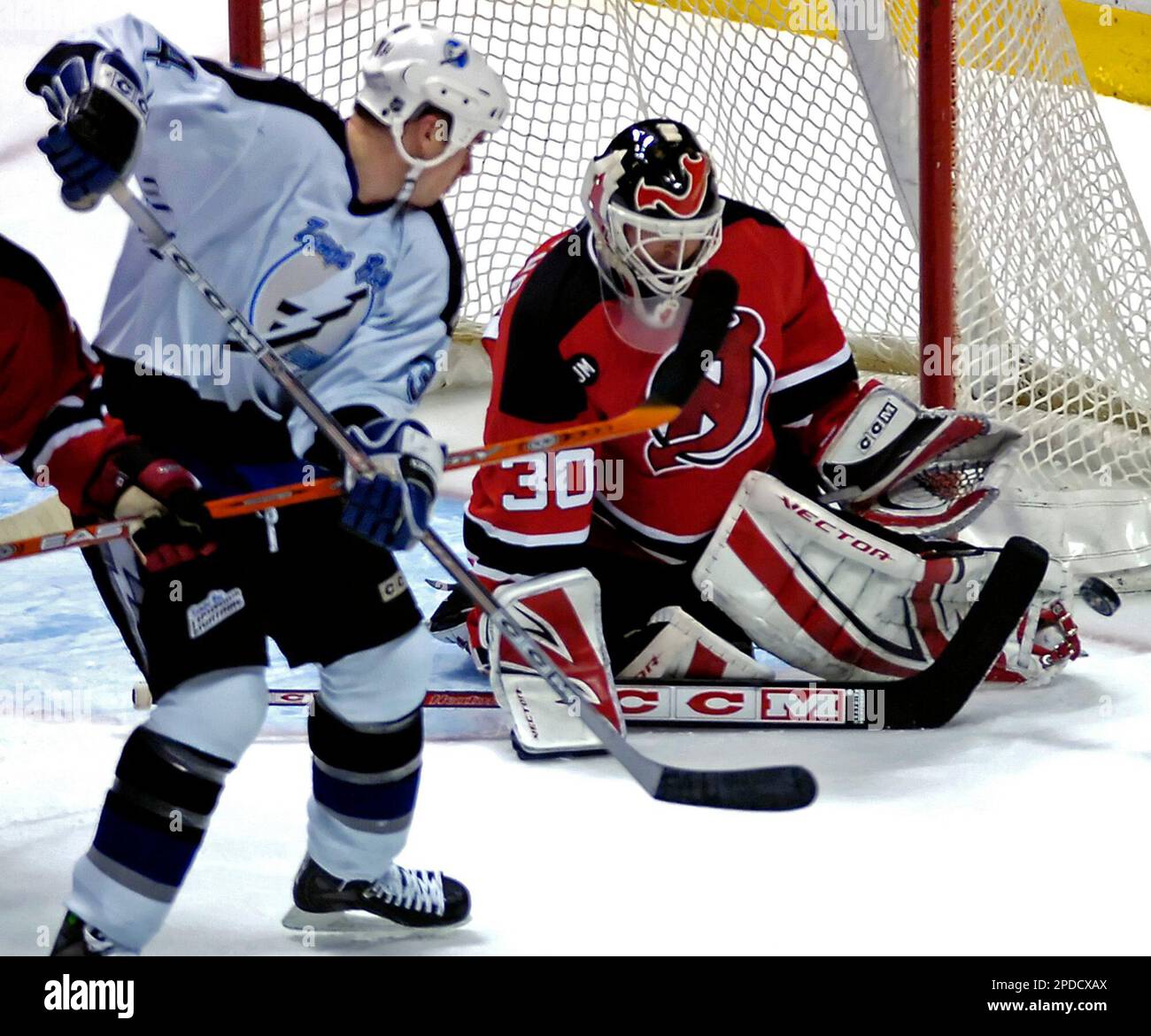 New Jersey Devils goaltender Martin Brodeur, right, makes a save on a ...
