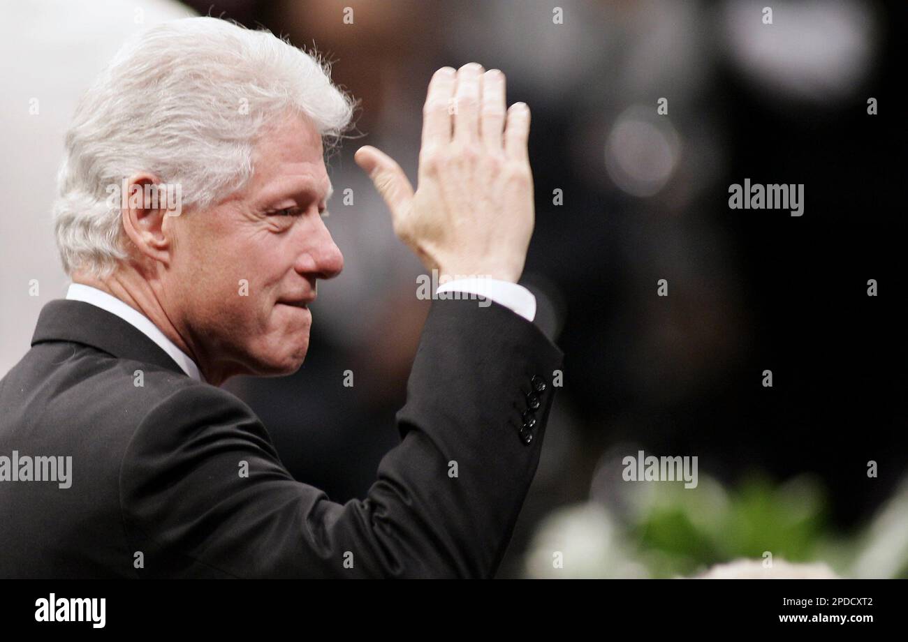 Former Pres. Bill Clinton salutes as he arrives for the Coretta Scott ...