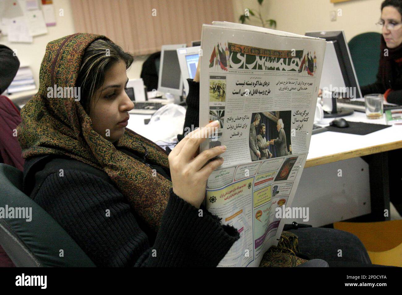 Iranian journalist Elahe Khosravi, reads Iranian daily newspaper ...