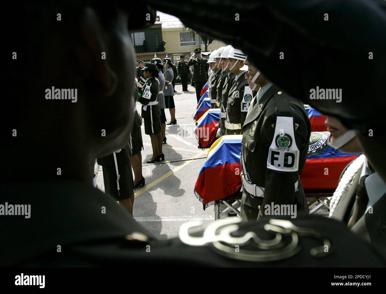 Police officers accompany coffins during the funeral of six of seven ...