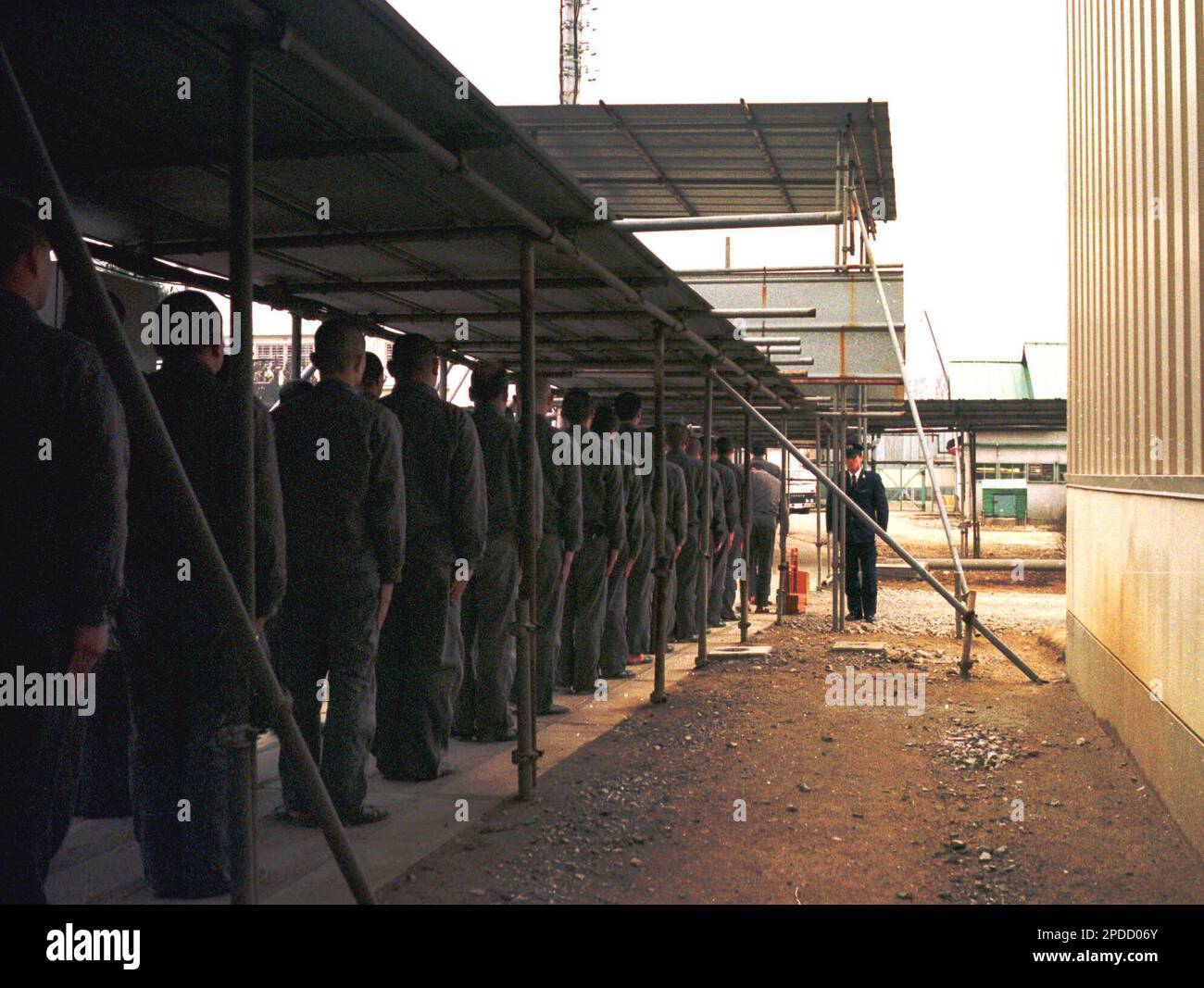 ** FILE ** Uniformed inmates line up in formation before they march in ...