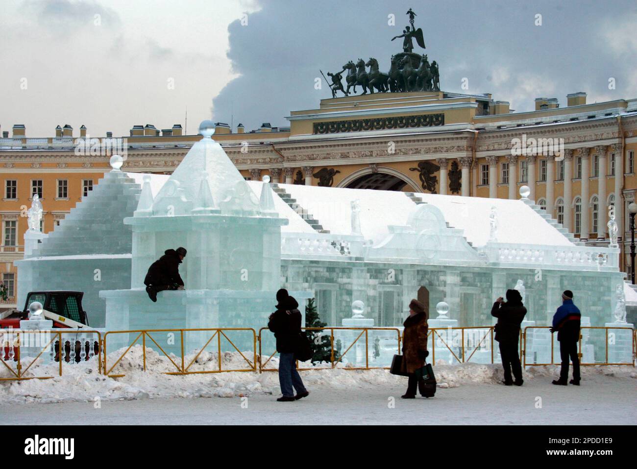 A sculptor works on an ice palace built in Palace Square in St ...