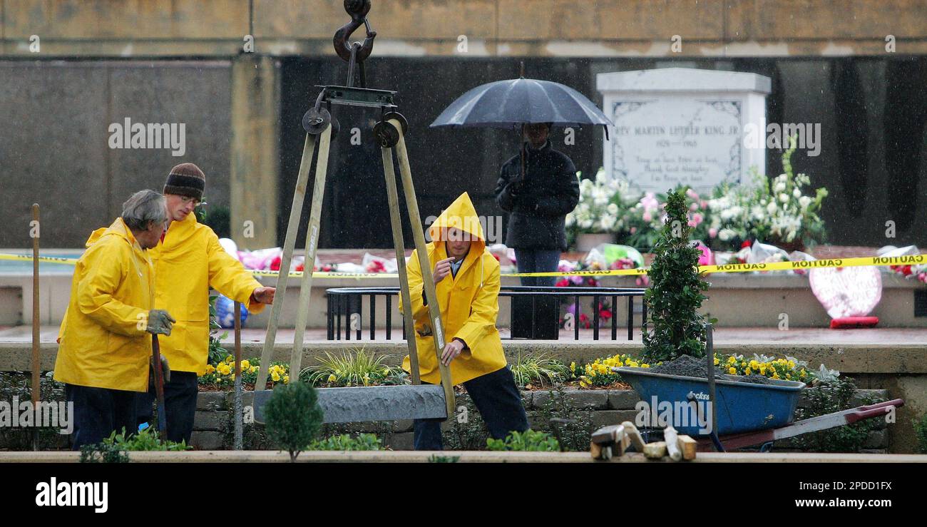 Workers construct a temporary gravesite for Coretta Scott King opposite ...