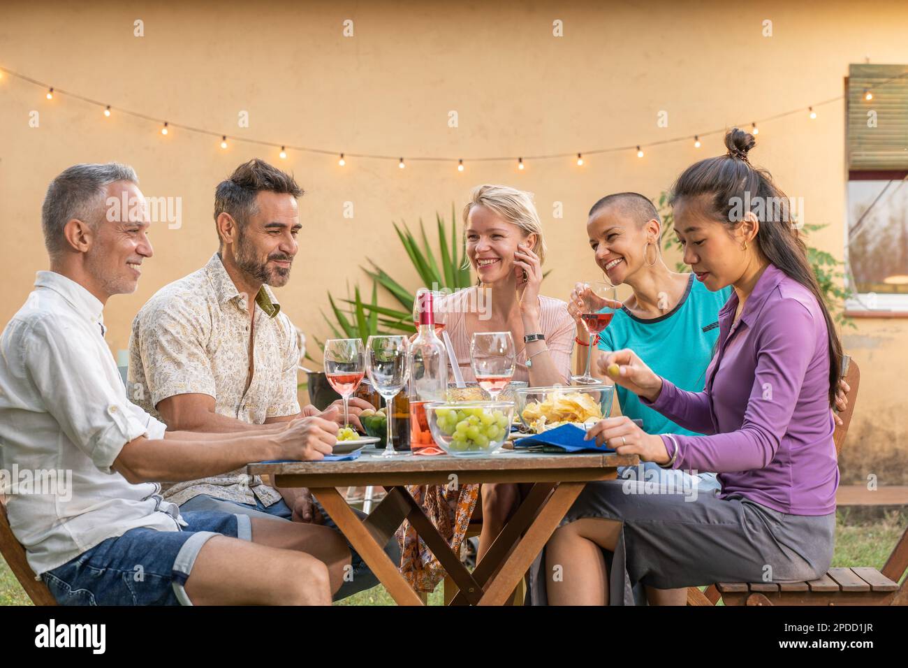 Middle-aged cheerful people around the table Stock Photo - Alamy