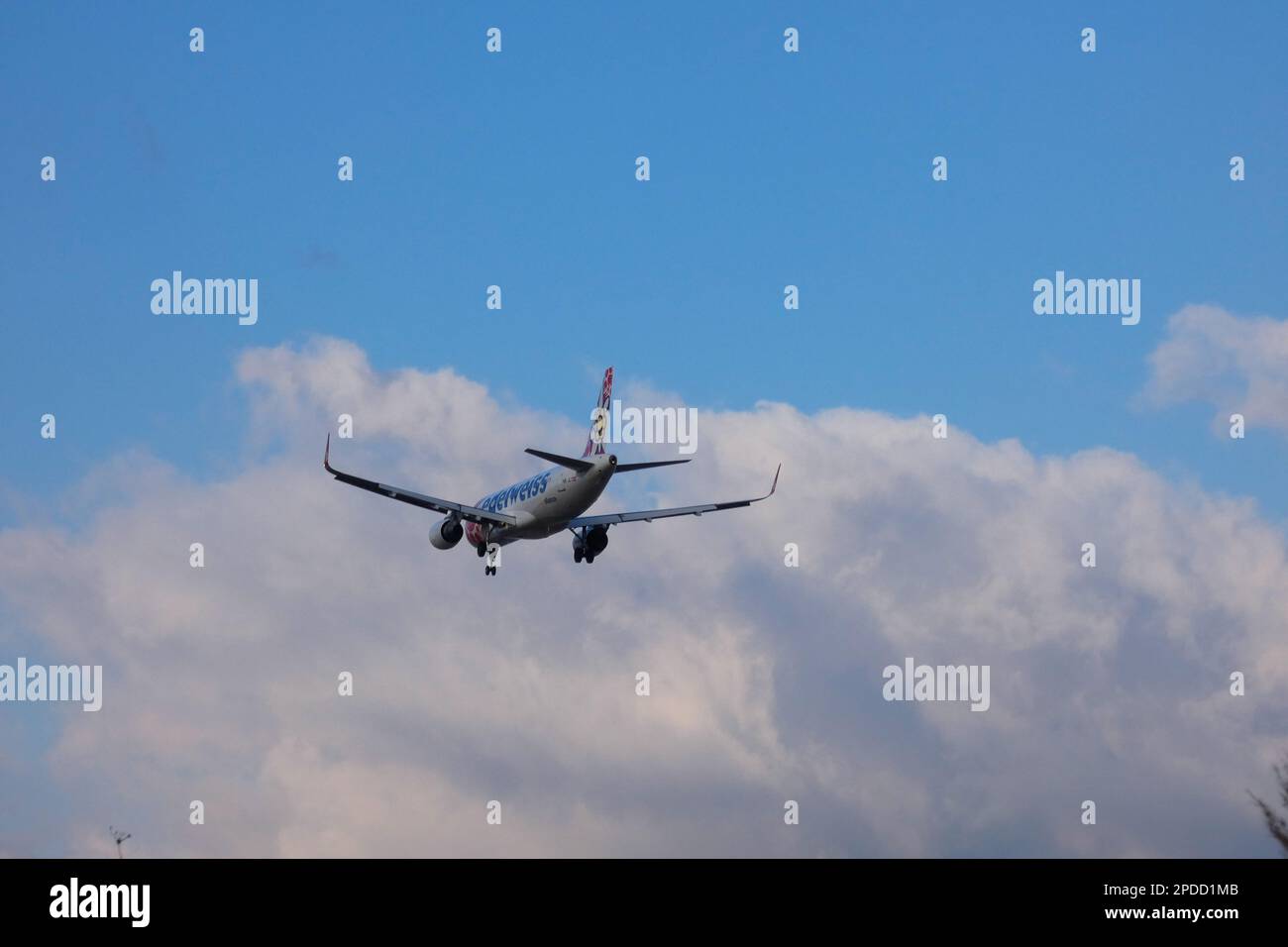 Commercial aircraft overflying the sky and arriving at airport Stock ...