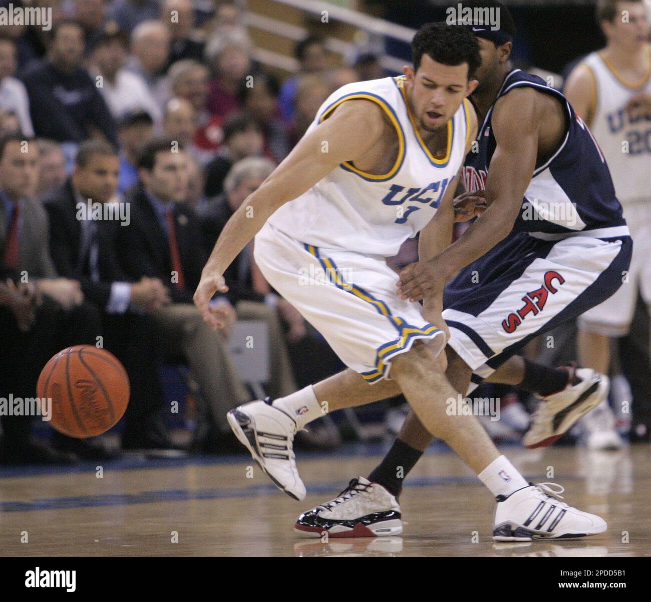 UCLA's Jordan Farmar, left, has the ball knocked away by Arizona's ...