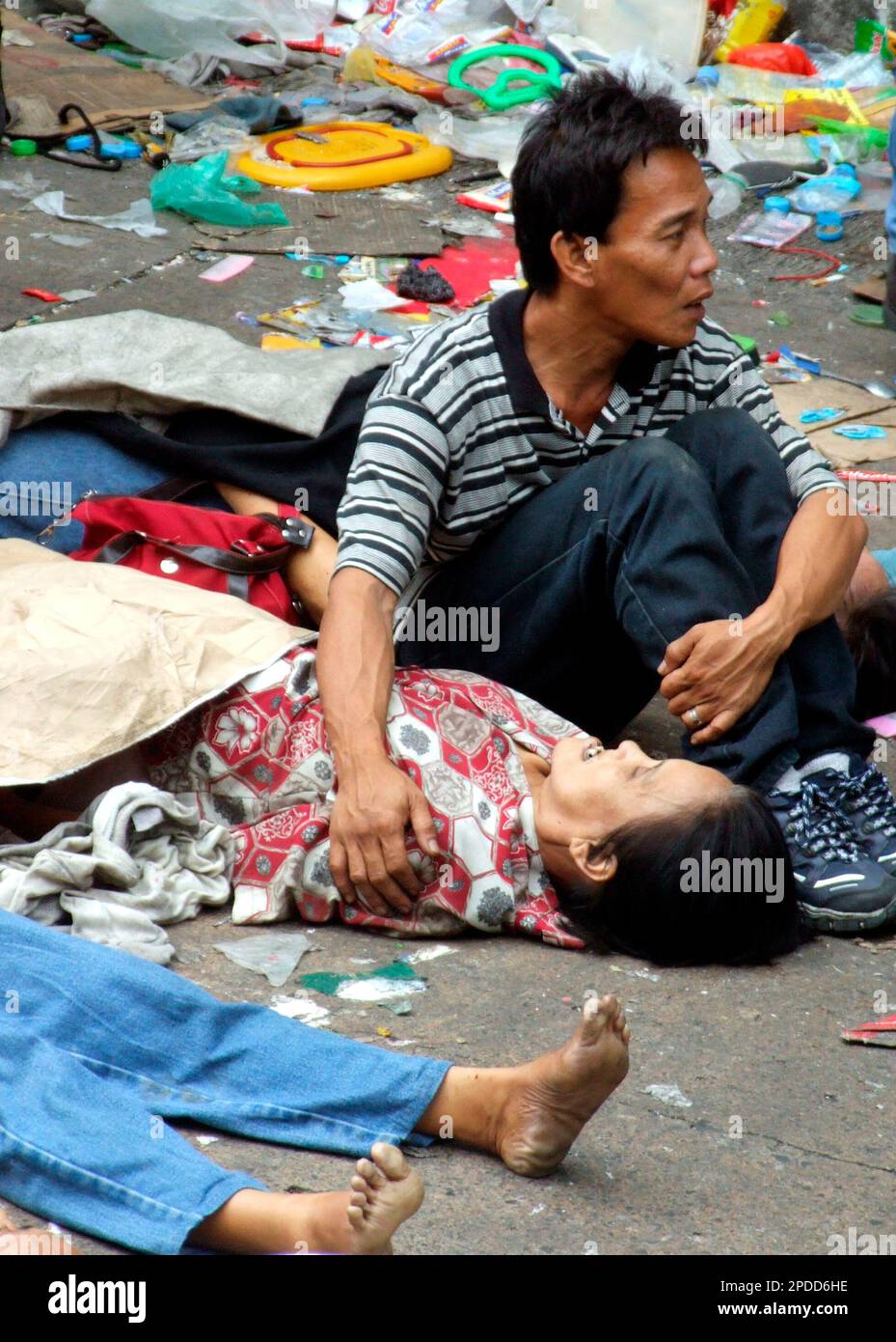 A man mourns over his dead relative, one of at least 73 victims of a ...