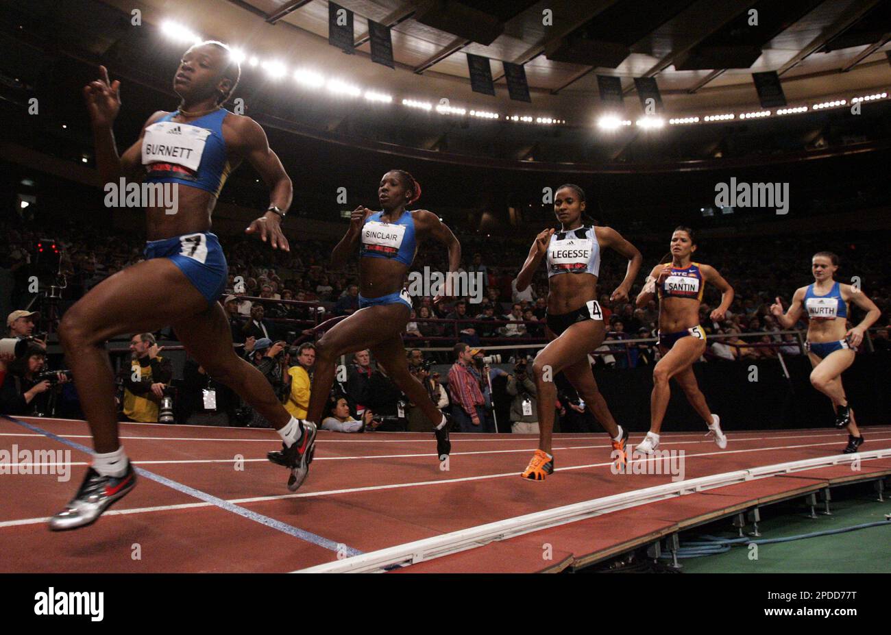 Kenia Sinclair, second from left, pulls around the outside of Marian ...