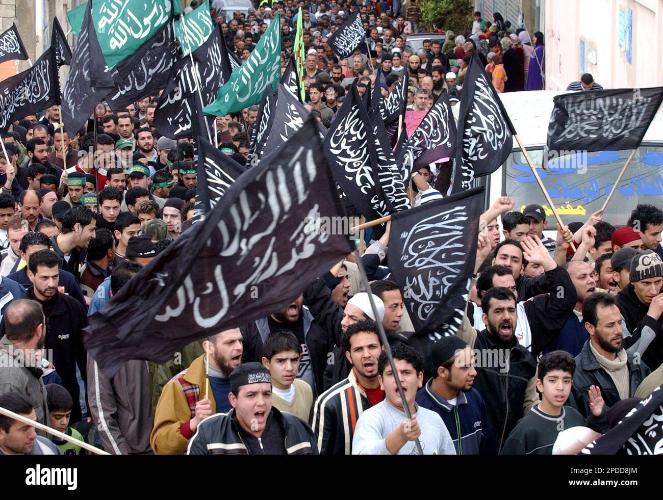 Palestinian Muslim demonstrators wave black and green flags with ...