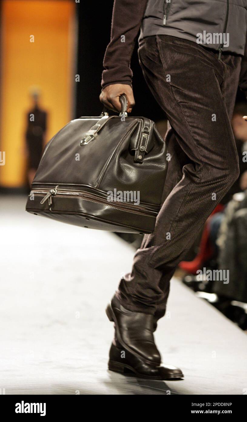 A male model carries a bag and wears a design from the fall 2006 ...