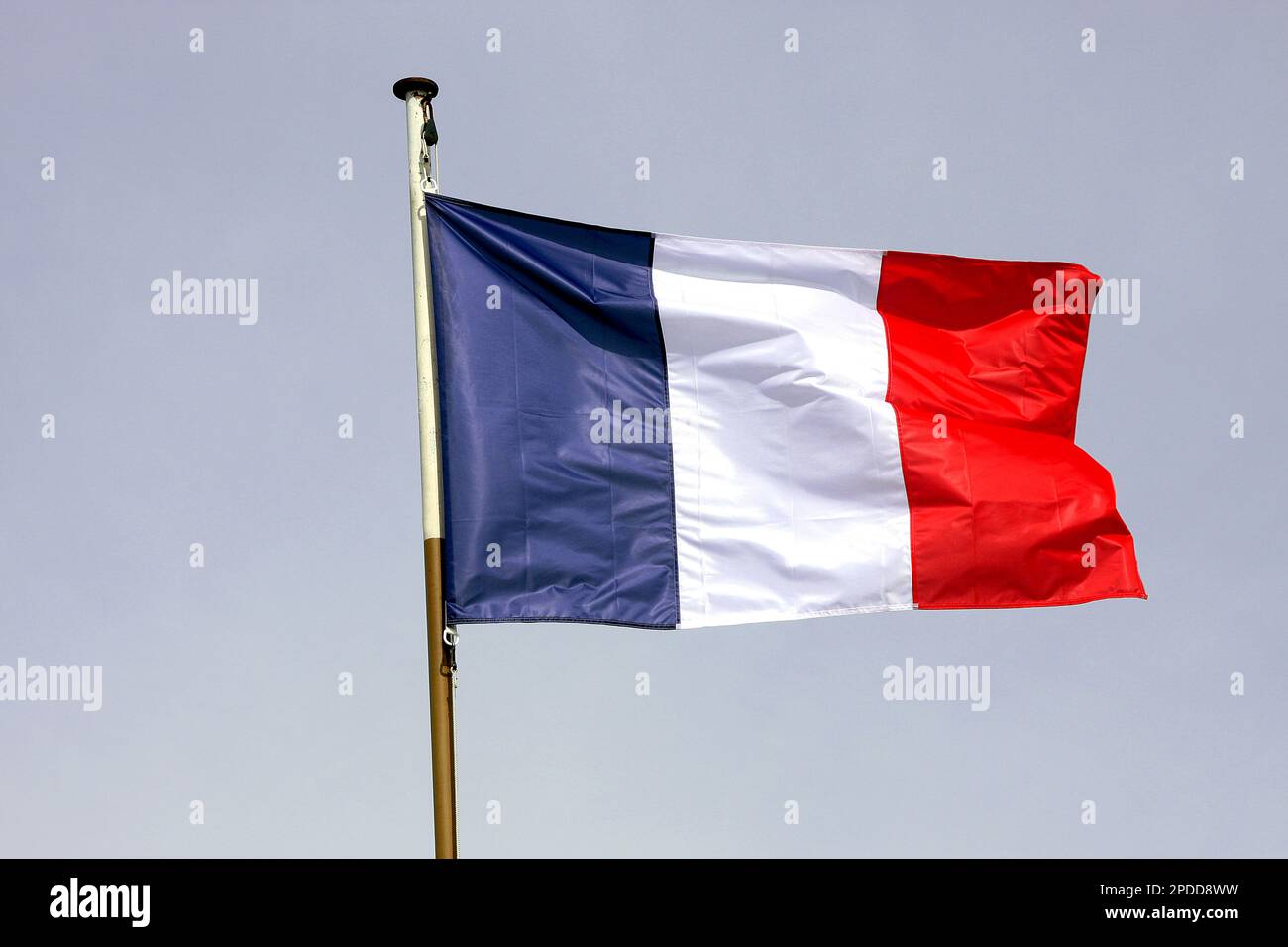waving French flagg against blue sky, France Stock Photo - Alamy