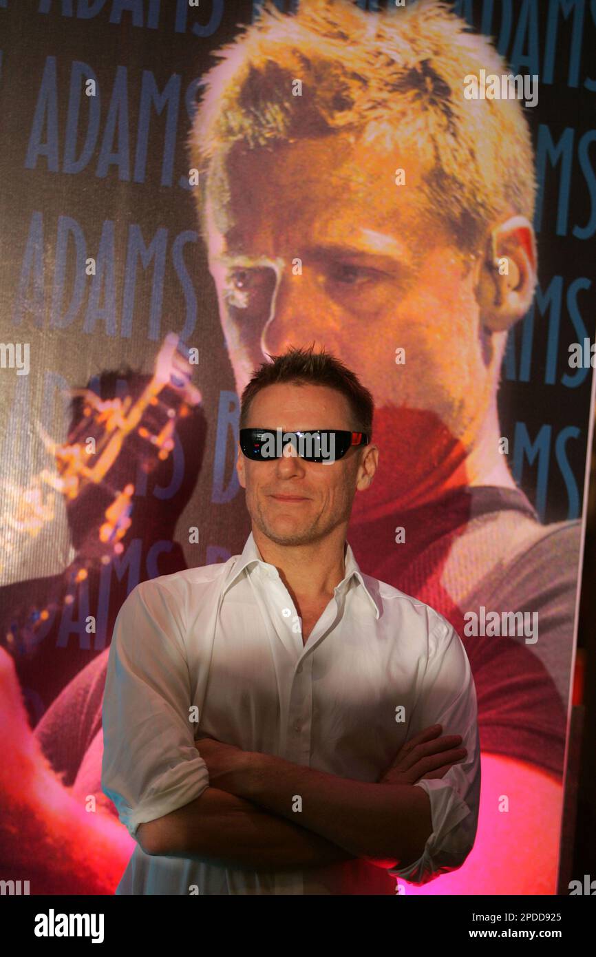 Rock singer Bryan Adams pose in front of his poster after a press ...