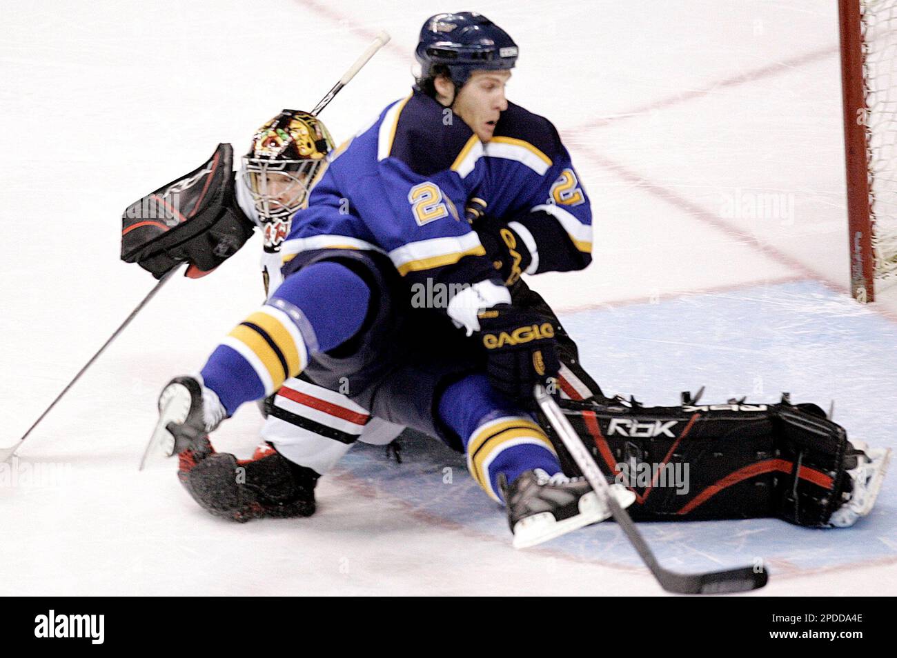 St. Louis Blues' Dennis Wideman falls over Chicago Blackhawks goalie ...