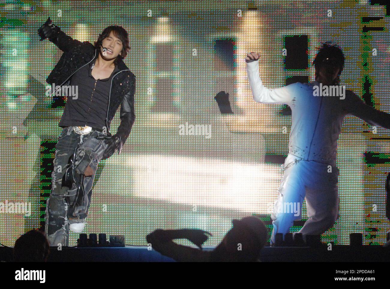 Rain, a Korean pop star and actor,left, and a backup dancer perform in ...