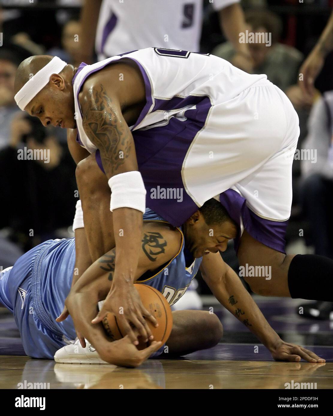 Sacramento Kings guard Bonzi Wells, top, and Denver Nuggets forward ...