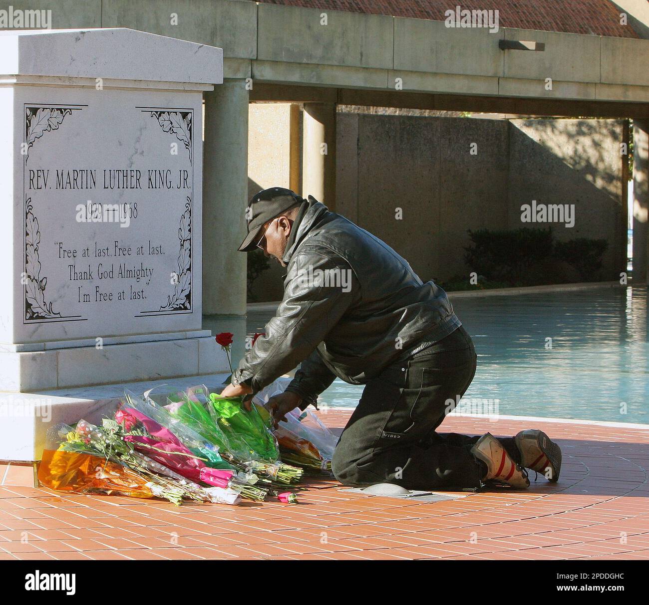 King Center employee Bobby Blacklock arranges flowers in front of the ...