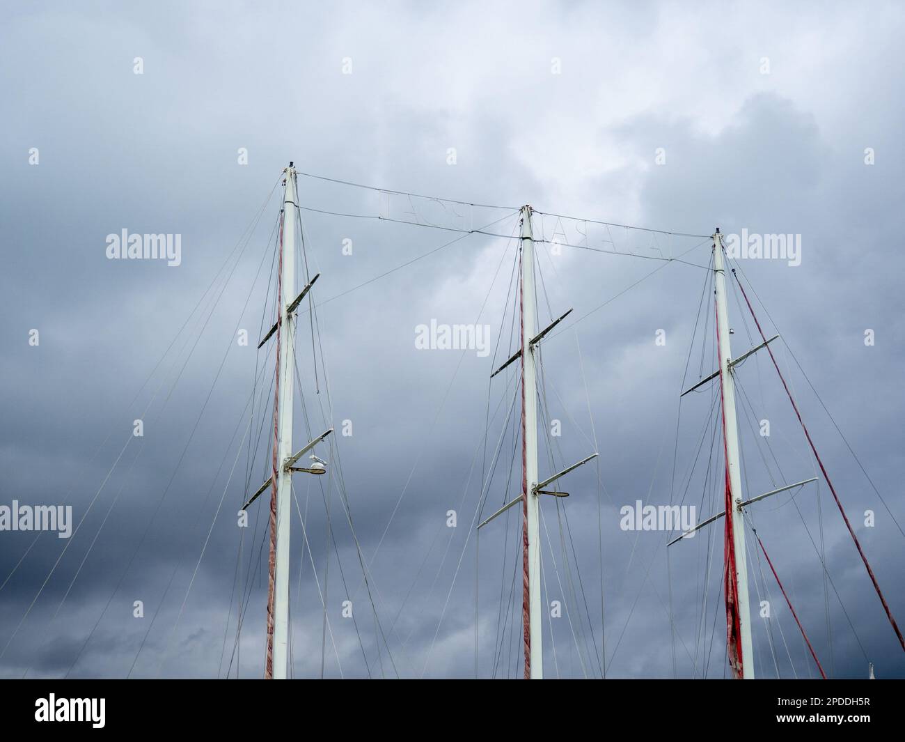masts of a ship without sails. The sails are down. Overcast sky. Ship ...